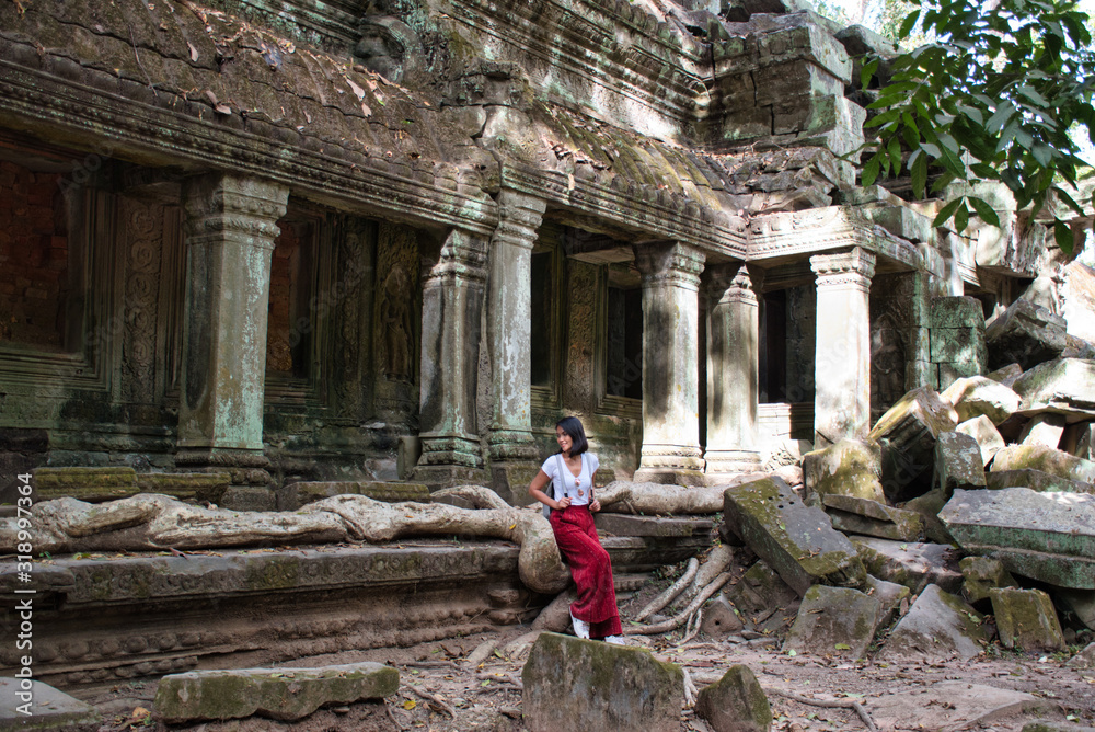 Beautiful, pretty, young Thai girl is exploring the ancient ruins of ...