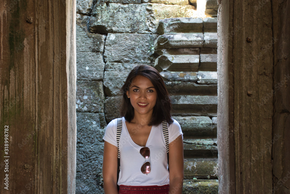 Beautiful, pretty, young Thai girl is exploring the ancient ruins of ...