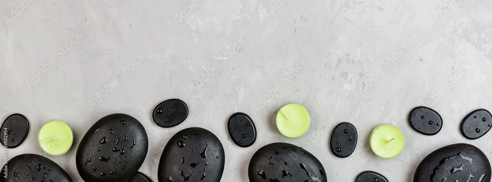 Top view of hot spa stones set for massage treatment on gray concrete ...