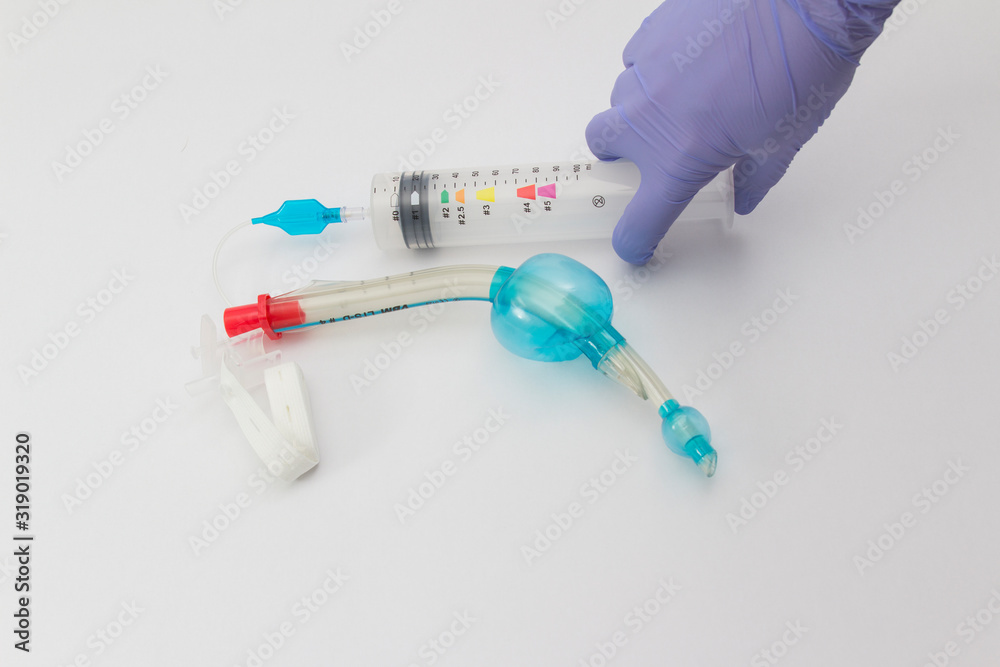 Laryngeal tube kit filling with air by a doctor isolated at the white ...