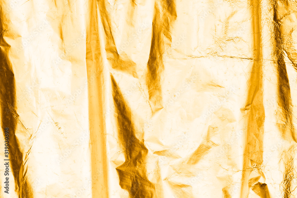 Gold texture, gold-plated surface made of crumpled fabric. Thin metal ...