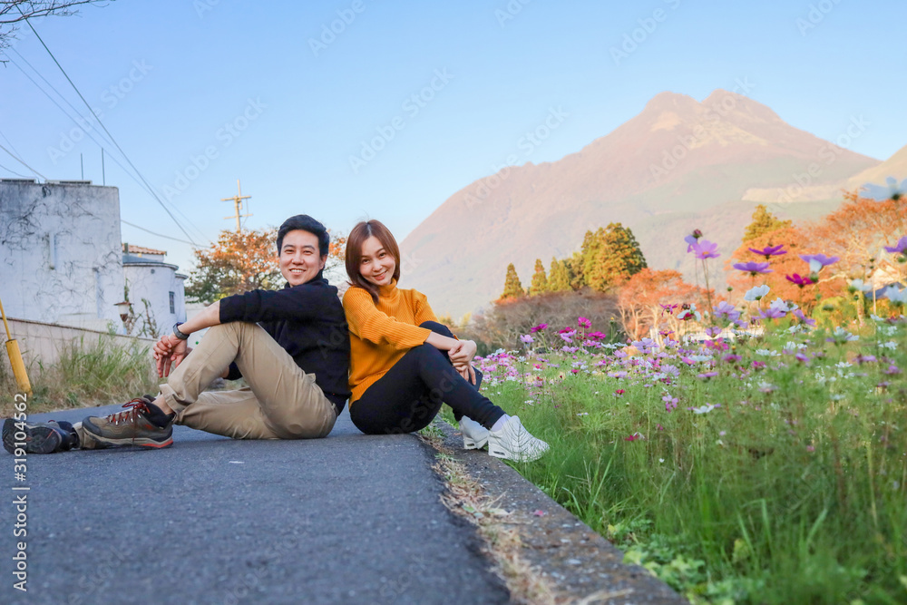 Young Couple sitting in poppy field of flowers in Yufuin Town, Oita, Japan Stock Photo | Adobe Stock