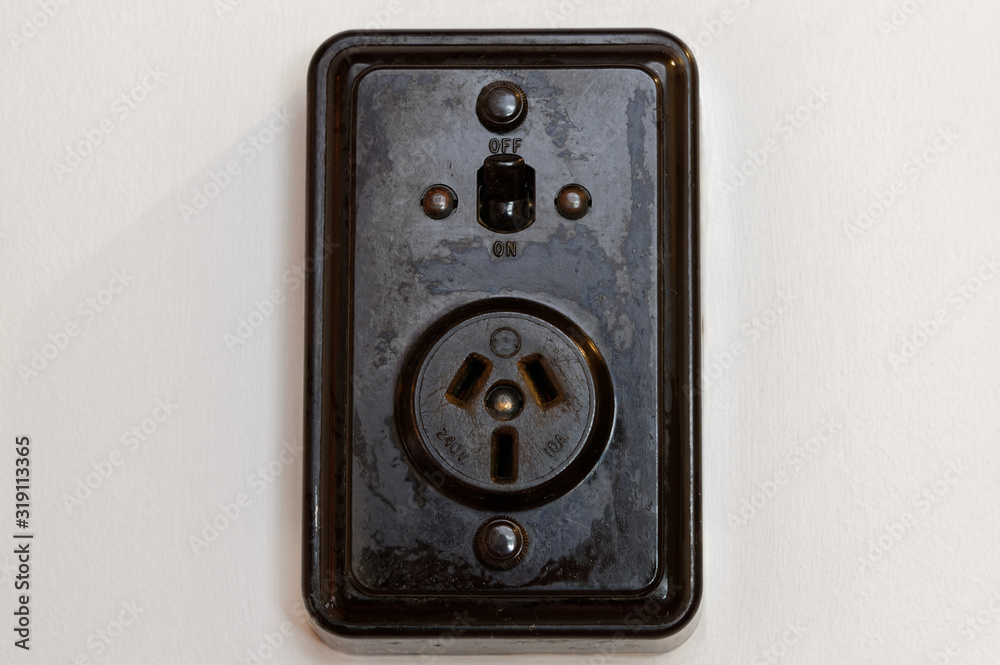 An old bakelite New Zealand power socket with an on and off switch ...