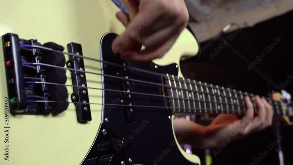 Technique of playing the bass guitar. The right hand of a musician ...
