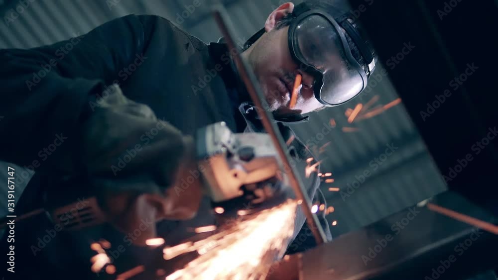 Metal cutting carried out by a male welder Stock Video | Adobe Stock