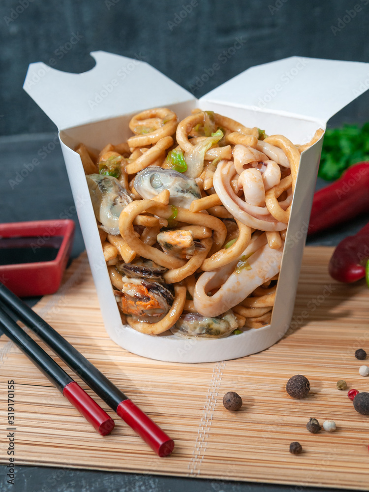 Wok box with noodles, squid, mussels, Beijing cabbage, ginger and ...