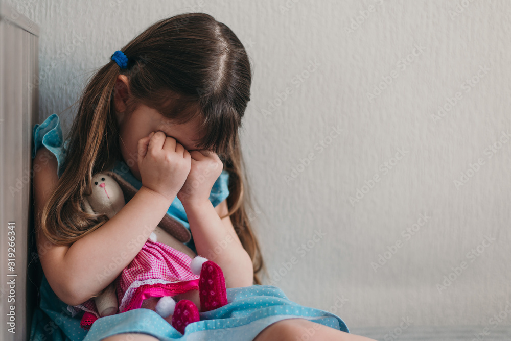 Sad little girl crying covering her face with hands Stock Photo | Adobe ...
