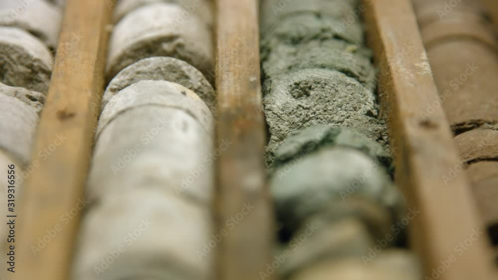 Sedimentary rock core samples from geological borehole in wooden box ...