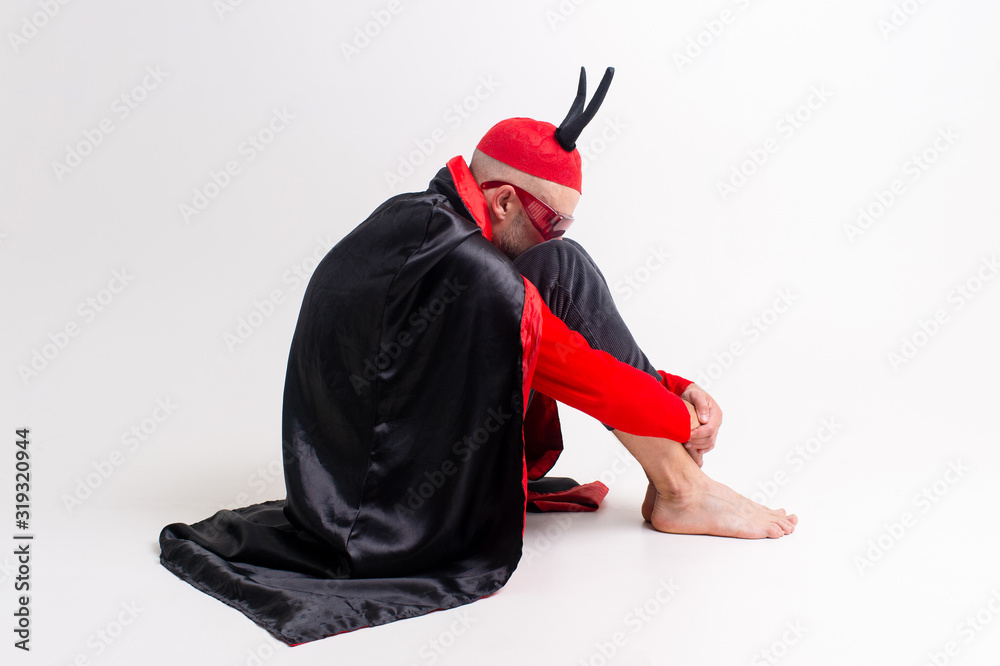 Srange unhappy man in dracula masquerade costume and devil horns ...