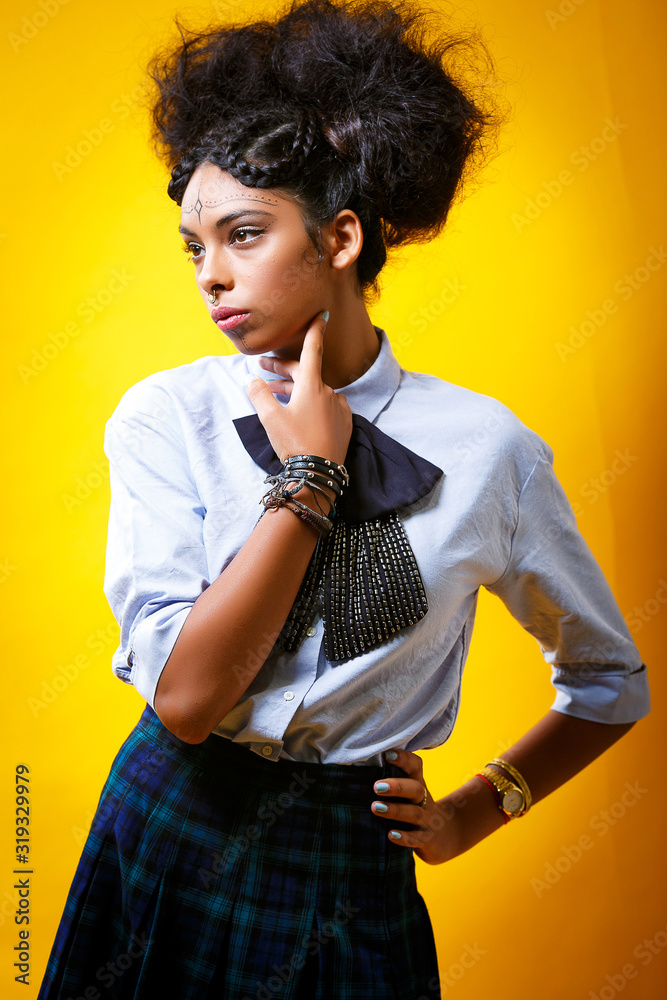 Young smart girl in a school uniform with a blue shirt and plaid skirt ...