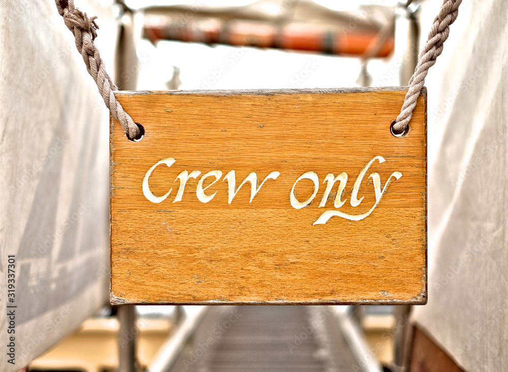 Big sign 'Crew only' over a classic sailing vessel personnel entrance ...
