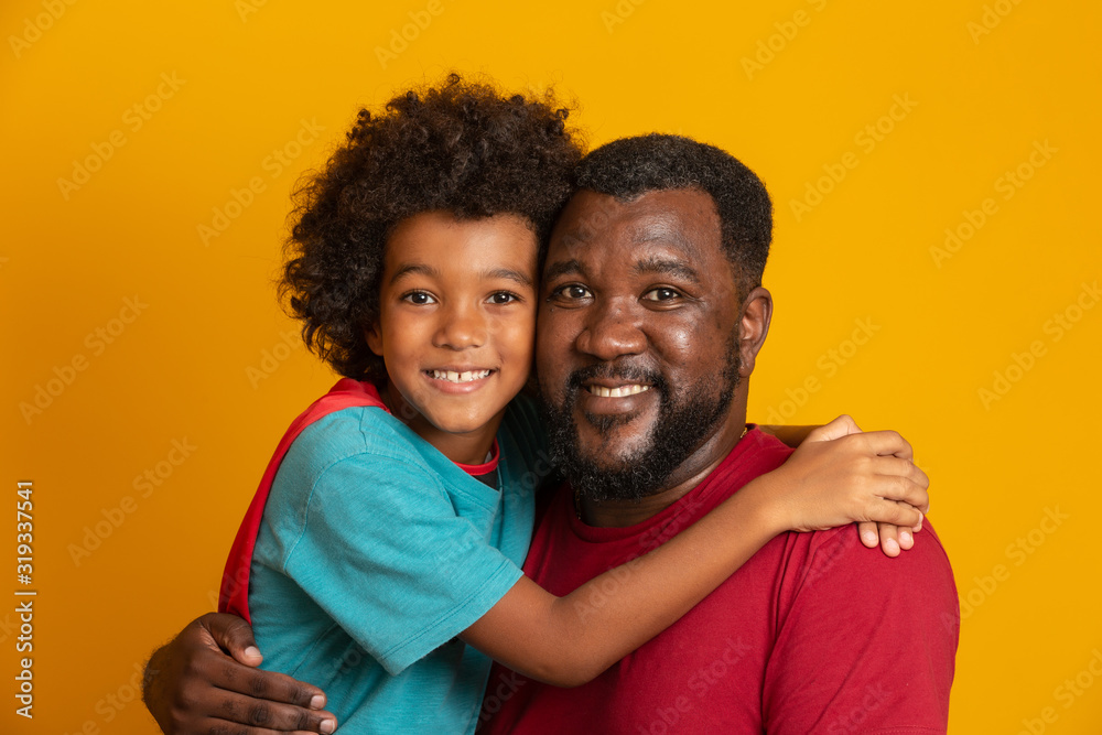 African Father and Son playing Superhero at the day time. People having ...