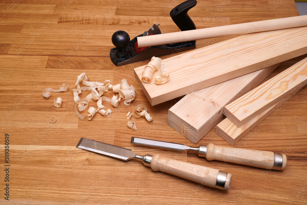 Carpenter's workbench planks, tools and wood shavings. Woodworking and ...