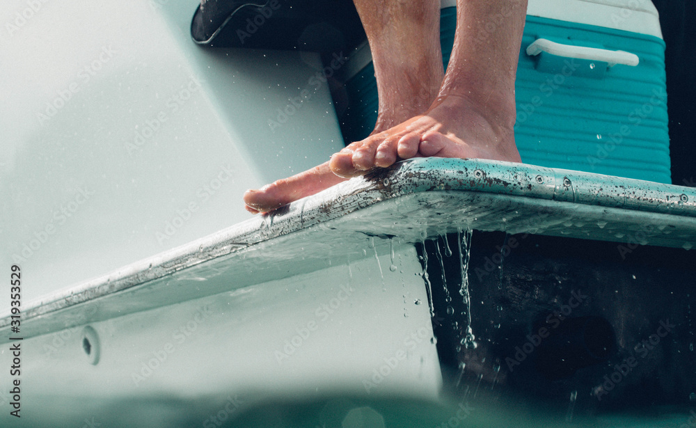 Mans feet dripping on the back of boat after a swim in the ocean Stock ...