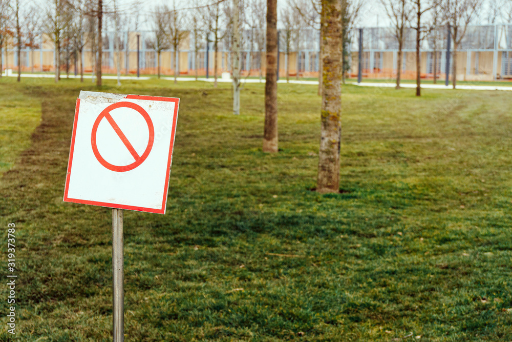 blank crossed-out prohibition sign on a well-kept green lawn for any ...