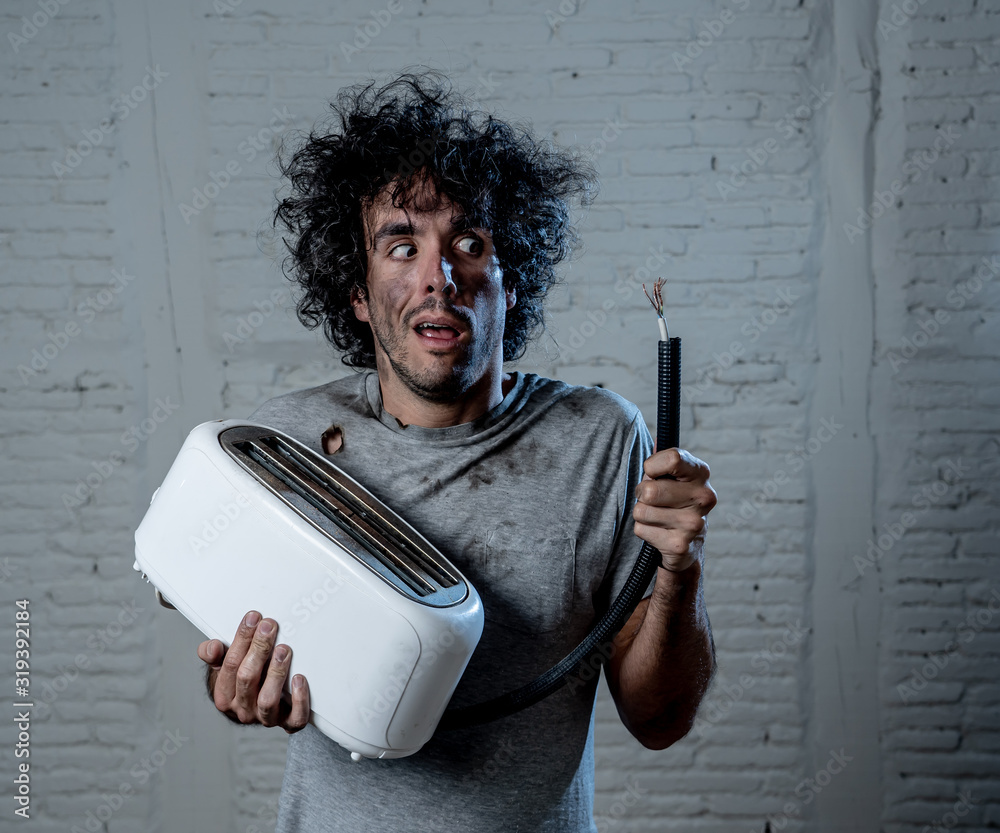 Funny man after suffering an electric shock fixing a toaster. Domestic ...