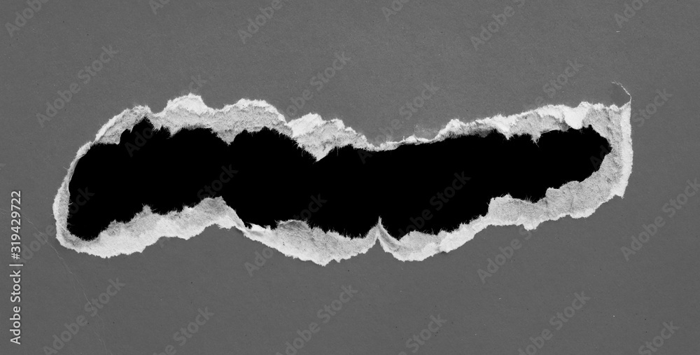 pieces of torn hole paper texture on black background, copy space ...
