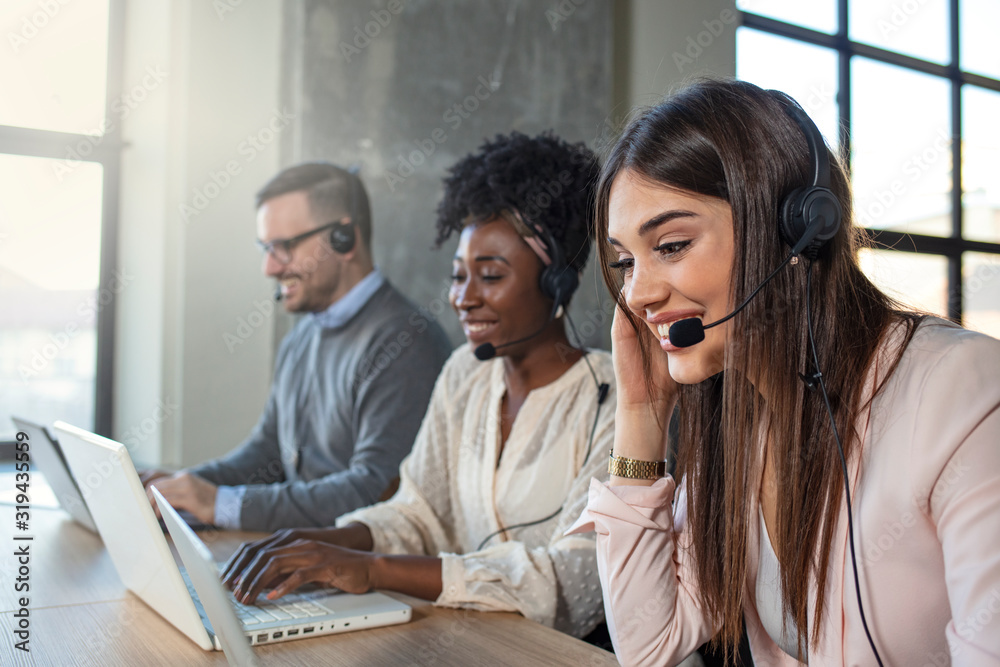 Customer service executive working at office. Colleagues working in a ...