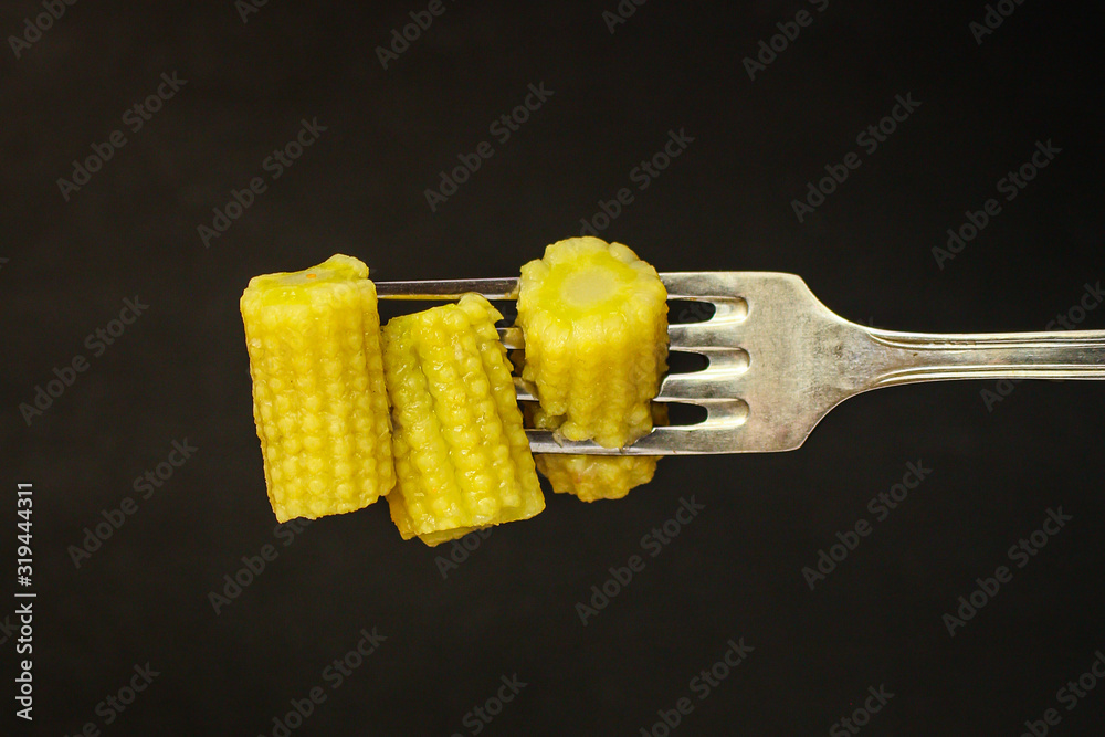baby corn on a fork, fresh vegetables (healthy food) menu concept. food ...