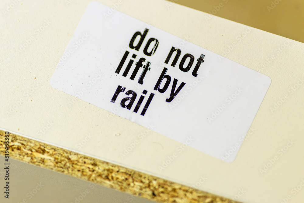 do not lift by rail text on wooden plank on construction site in ...