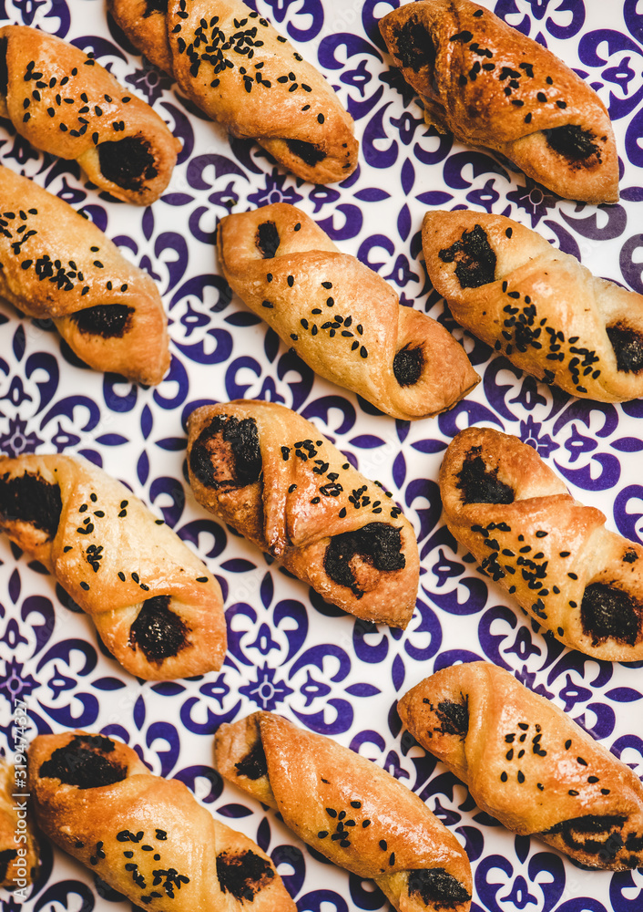 Flat-lay of Turkish traditional salty pastry with black olive paste ...