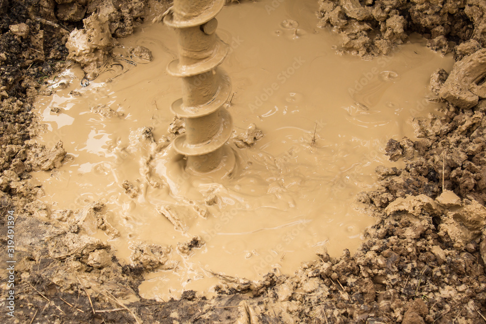 The process of drilling a water well with a winding drill Stock Photo ...