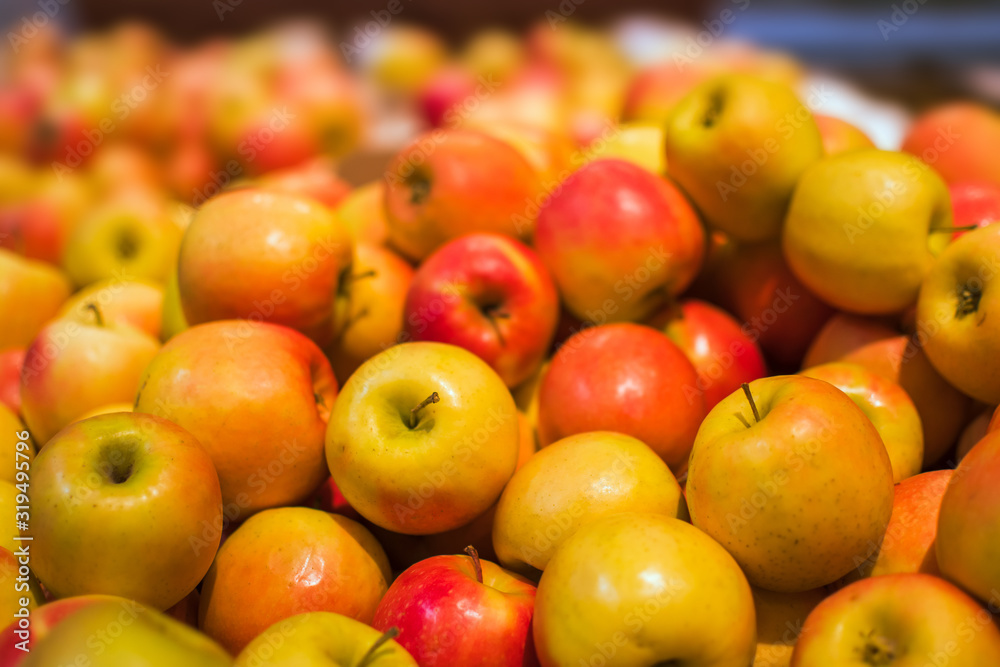 Red and orange apples background full of oranges. Fresh red apple on ...