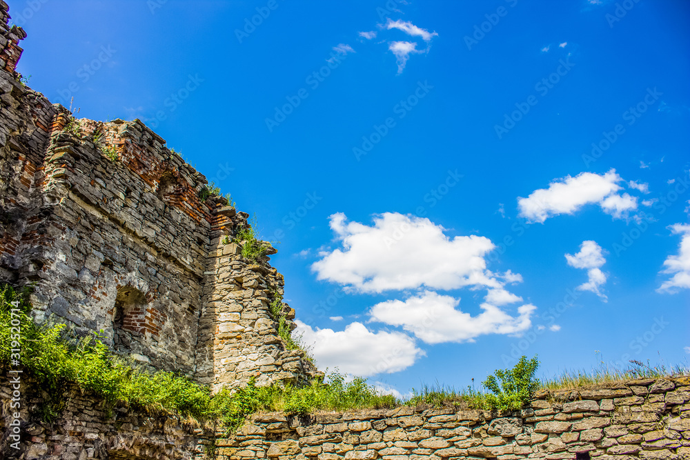 old ruins wall and blue sky background with empty space for copy or ...