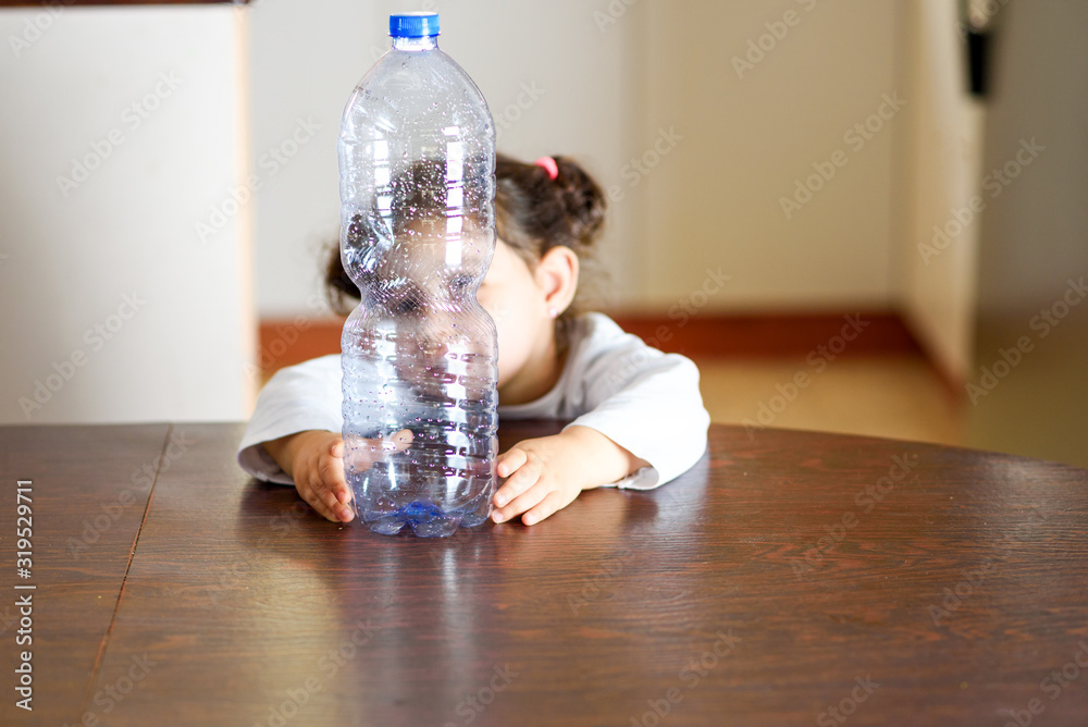 Child holding plastic bottle. Concept of awareness of the plastic ...