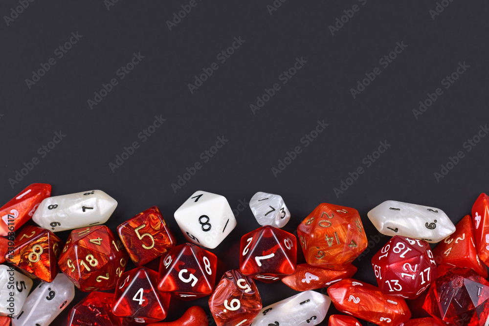 Background with different roleplaying RPG dice at bottom of dark black ...