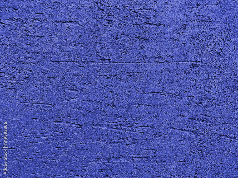 Putty plaster wall surface with cracks, painted to dark blue color ...