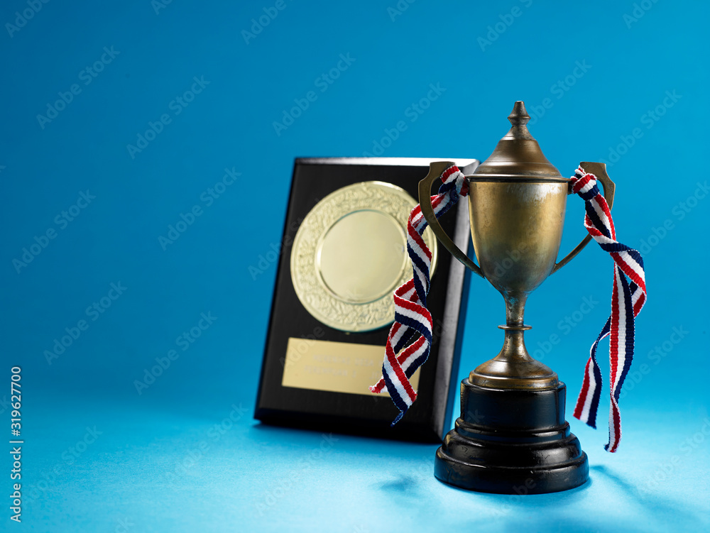 old trophy and plaque on the blue background Stock Photo | Adobe Stock