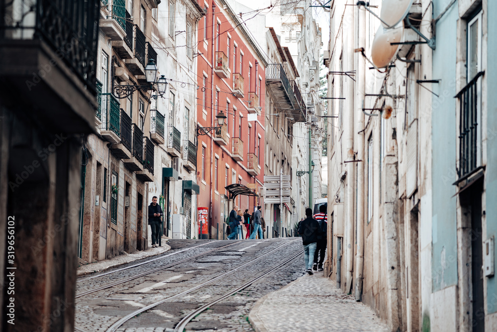 Lisbon, Portugal - Typical urban street scene, with cobblestone streets ...