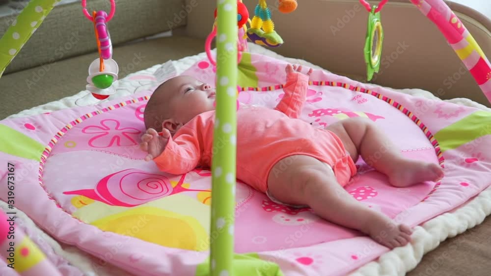 Adorable Baby Girl Lying on a Colorful Playing Mat. The Concept of ...