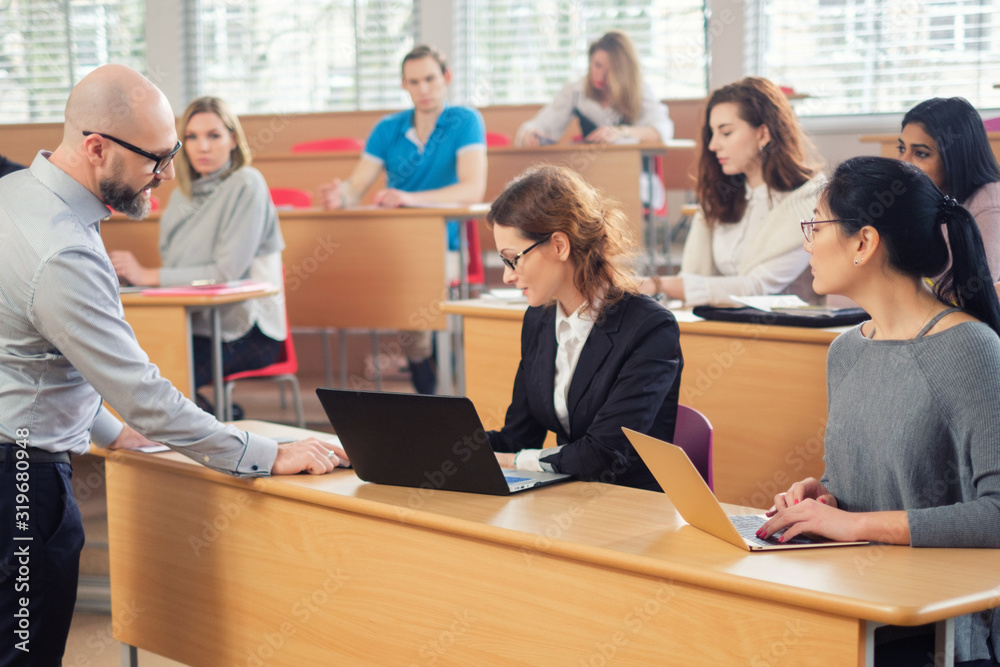 Lecturer and multinational group of students in an auditorium Stock ...