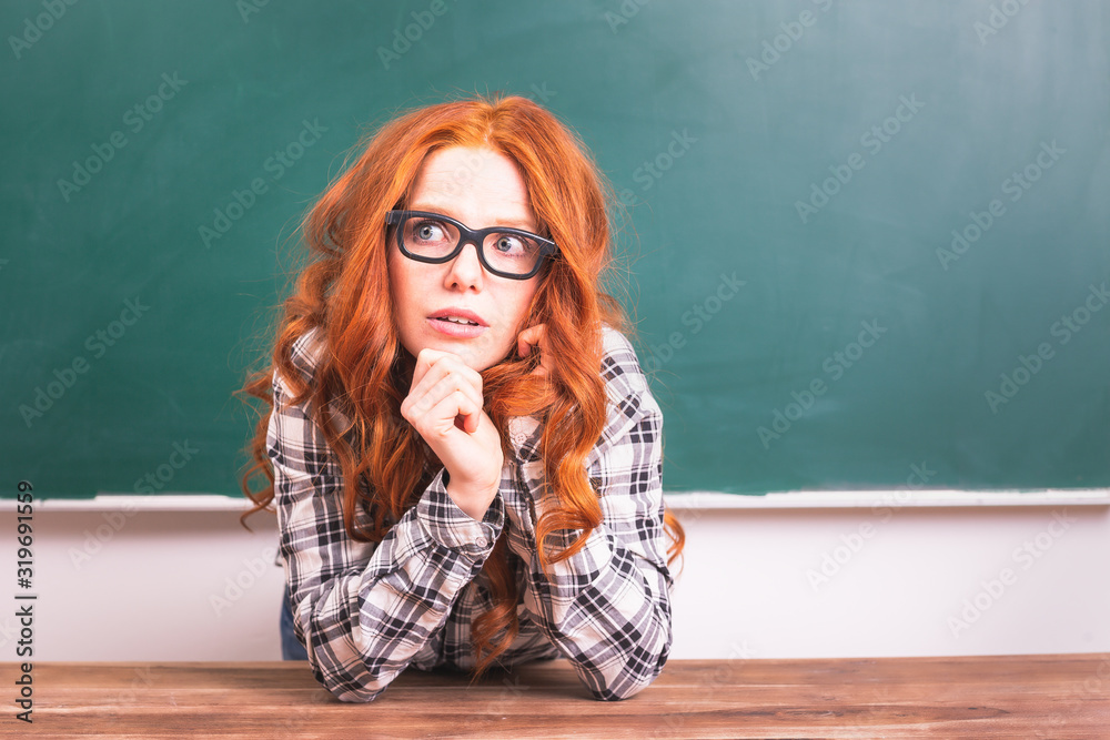 young trainees thinking in the classroom in front of blackboard in the ...