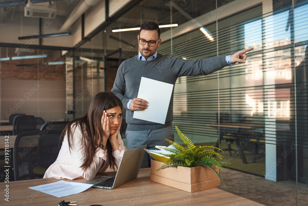 Boss dismissing an employee. Dejected fired office worker carrying a ...