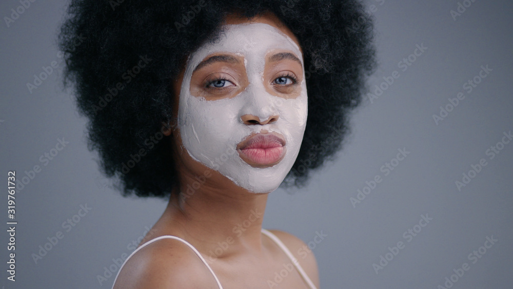 Portrait of gorgeous african girl with a purifying mask winking and ...