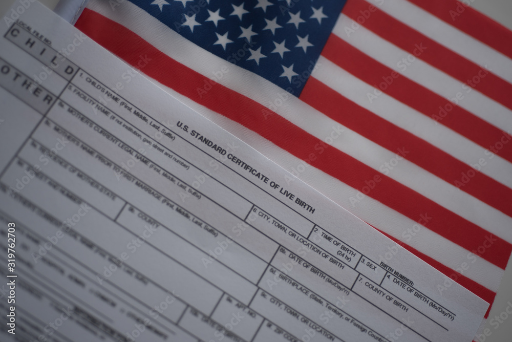 U.S. standard certificate of live birth application form next to flags ...