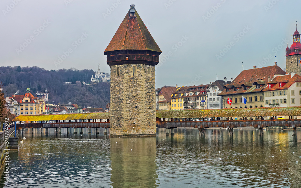 Famous wooden Chapel Bridge in Lucerne in Switzerland. Subsequently ...