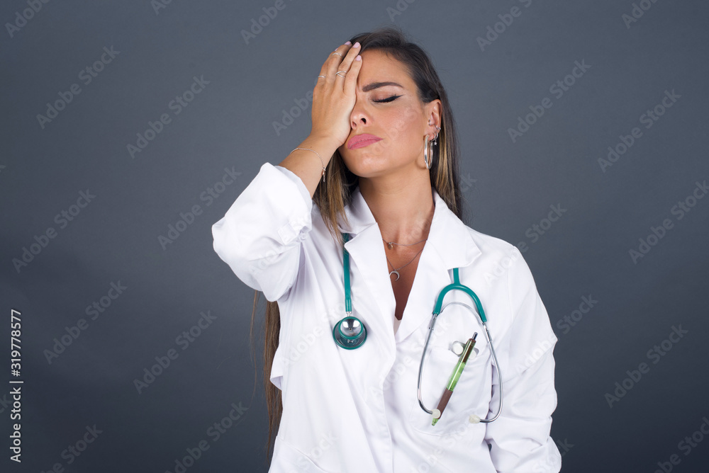 Frustrated brunette doctor woman holding hand on forehead being ...