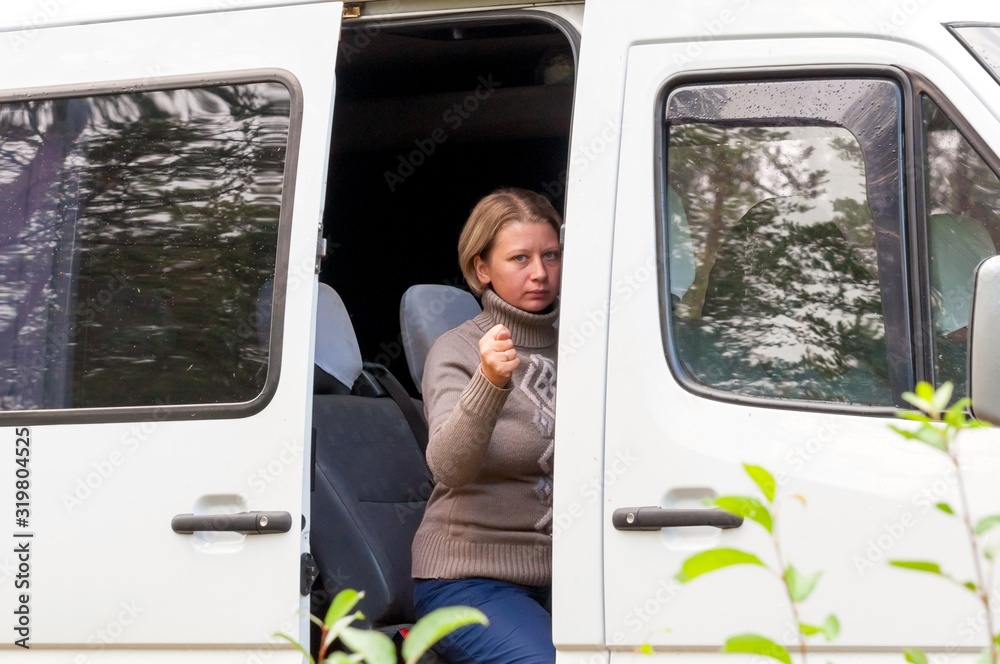 A pretty woman shows an obscene gesture. The concept of resentment and ...