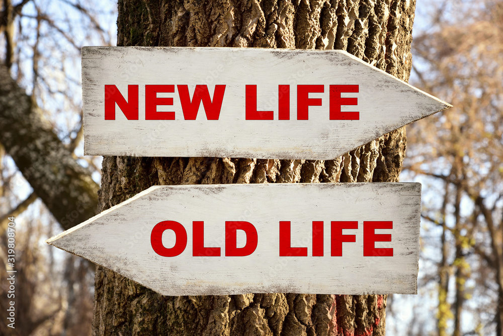 New life and old life messages on the weathered wooden signposts on a ...