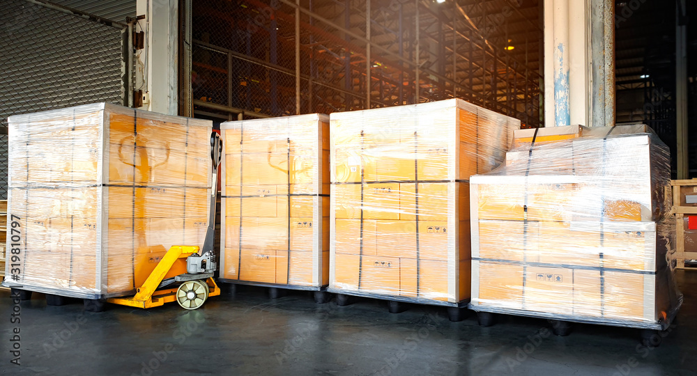 Packaging Boxes Stacked Wrapped Plastic on Plastic Pallets with L-shape ...