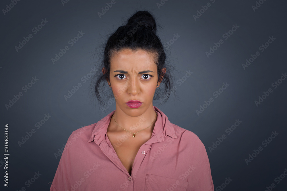 Portrait of outraged young woman with oval face, blue eyes and long ...