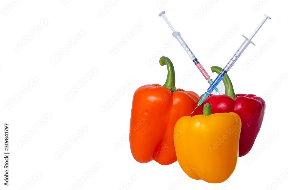 Genetically modified vegetables. GMO food concept. Syringes are stuck ...