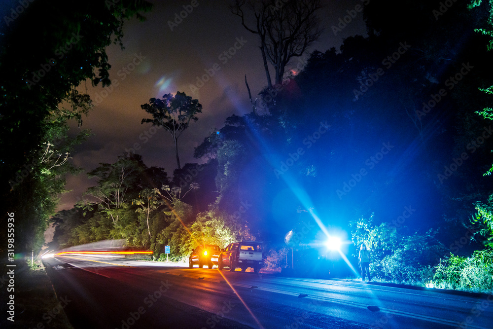 Scene of cars stopped on highway BR 101. Headlights in blue and yellow ...