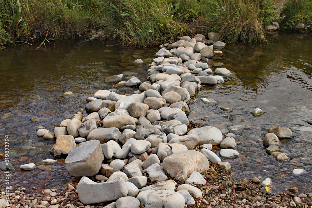 Rocks have been placed across the small stream by children playing at ...
