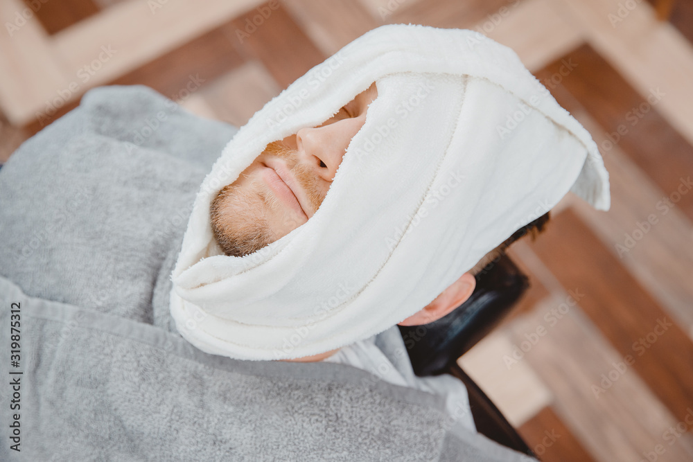 Barber steam face skin of man with hot towel before royal shave in ...