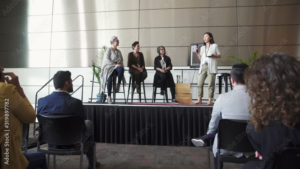 Female moderator leading panel Q and A on stage at conference Stock ...